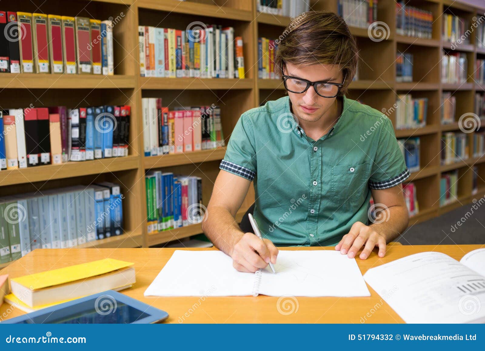 Student Sitting in Library Writing Stock Photo - Image of focused, book ...