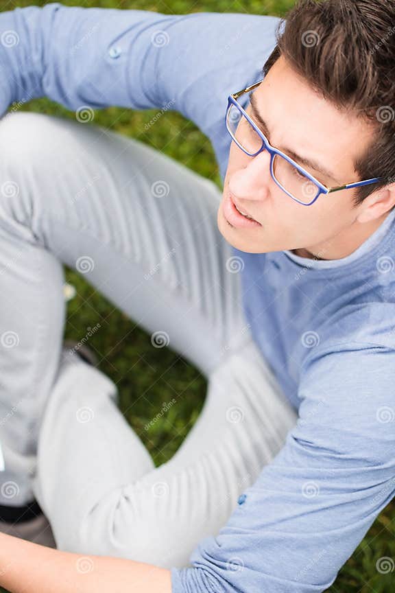 Student Sitting in the Park Looking Up Stock Image - Image of outdoor ...
