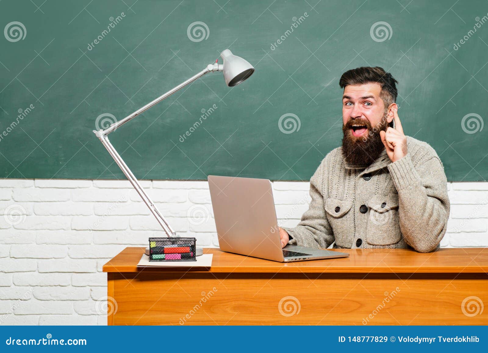 Student Sitting at Table and Writing on Notebook. Students Preparing ...