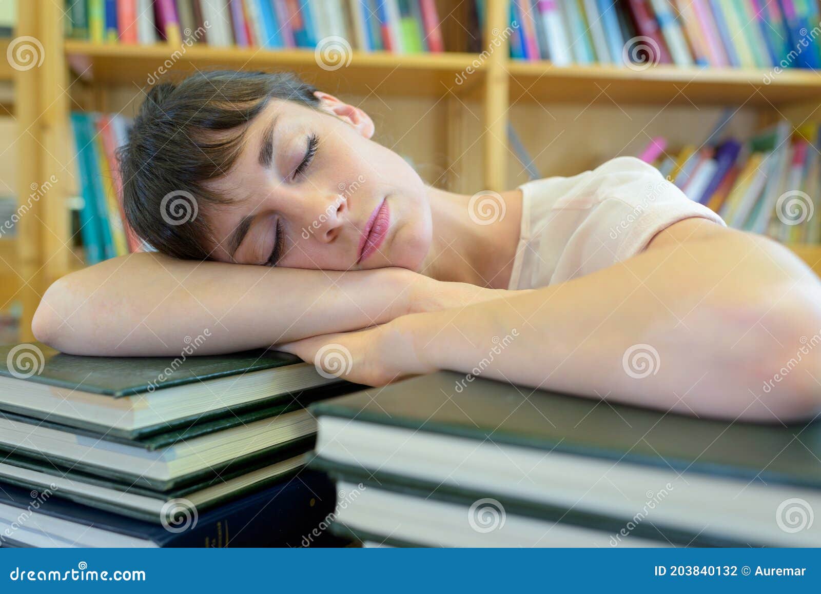 Student Sleeping on Books in Library Stock Photo - Image of sleep ...