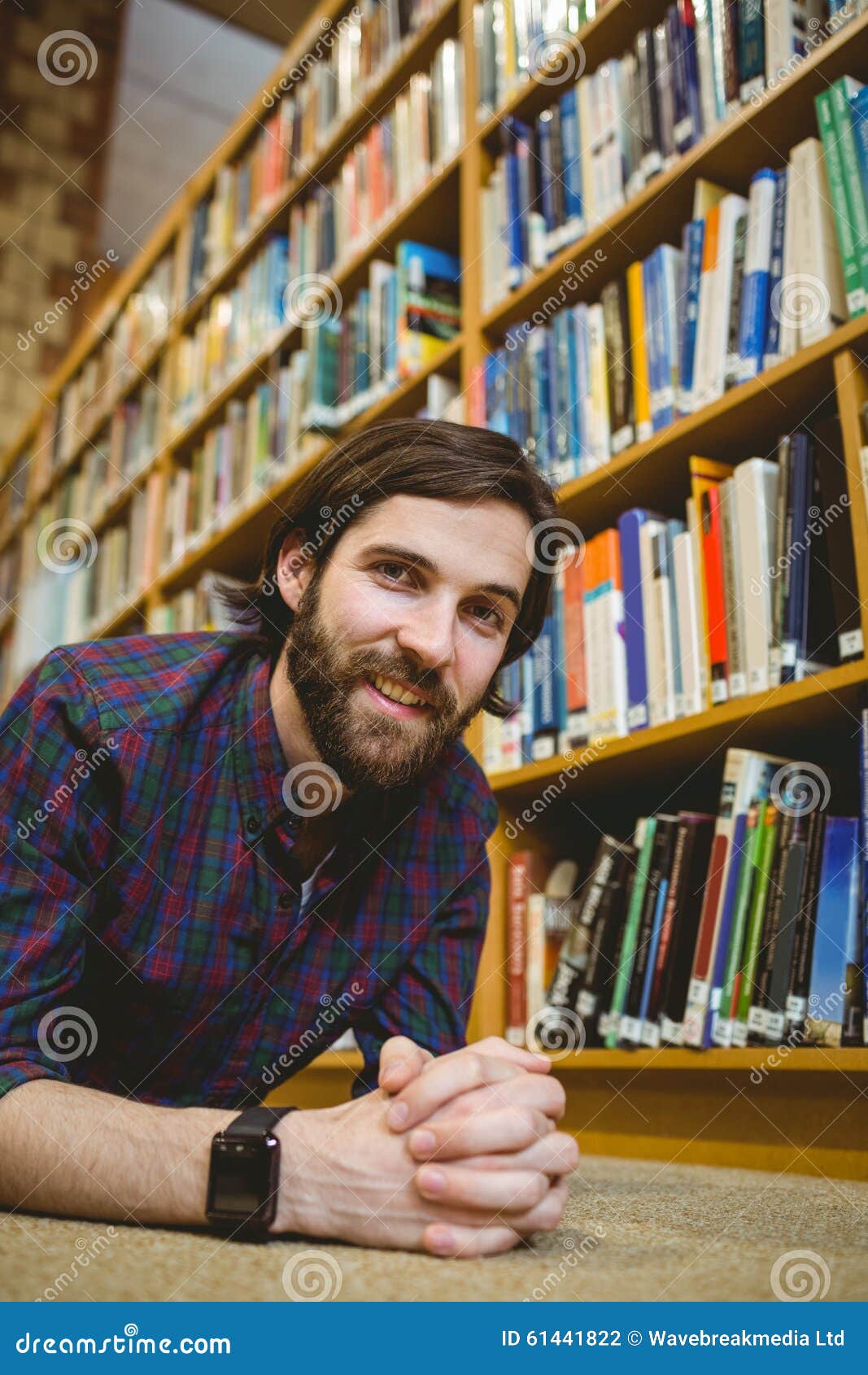 Student Smiling on Floor in Library Wearing Smart Watch Stock Photo ...