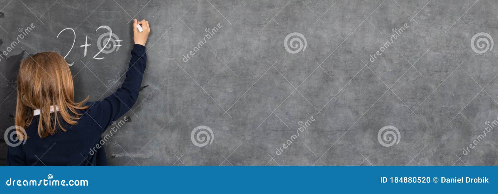 The Student Solves a Math Problem Standing at the Blackboard in Her ...