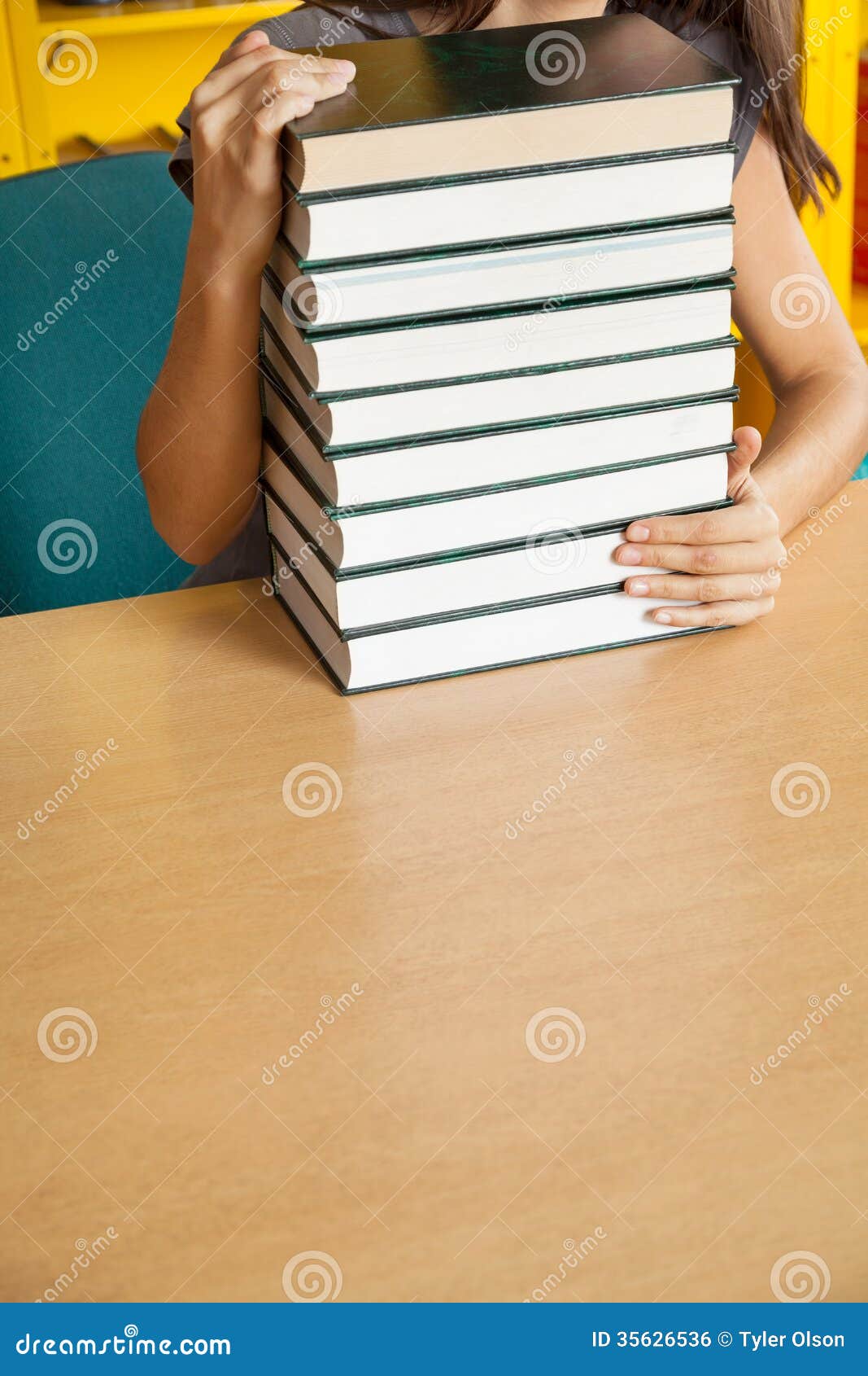 Student with Stacked Books at Table in College Stock Photo - Image of ...