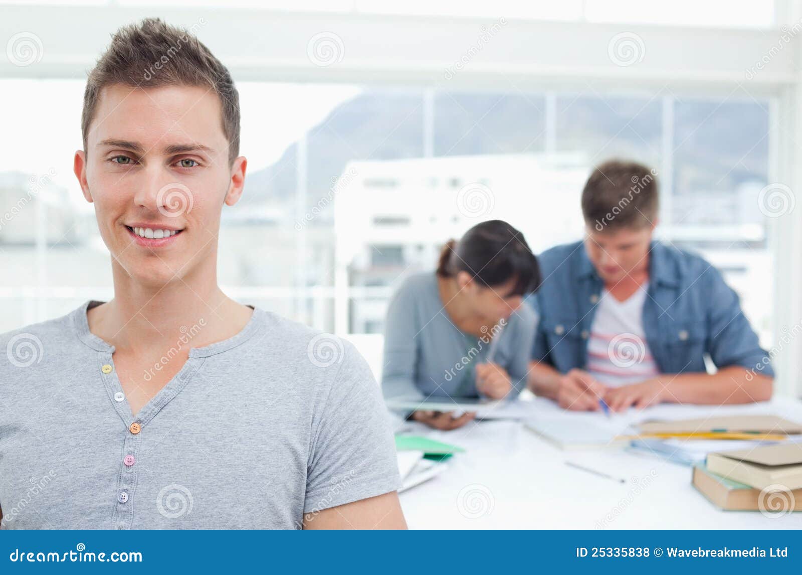 Student Standing in Front of His Fellow Students and Smiling Stock ...
