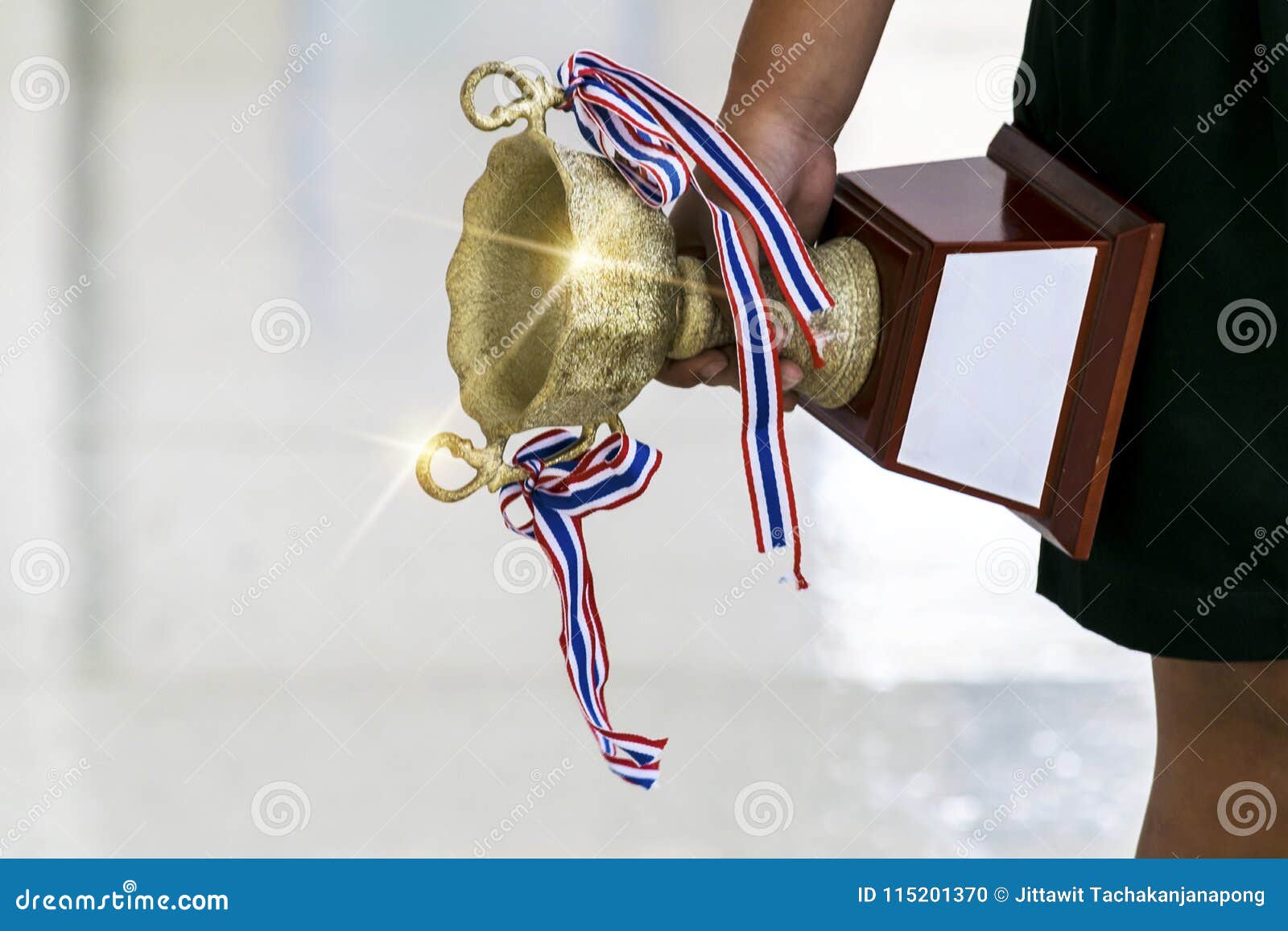 The Student Stands Holding the Trophy Received from the Competition ...
