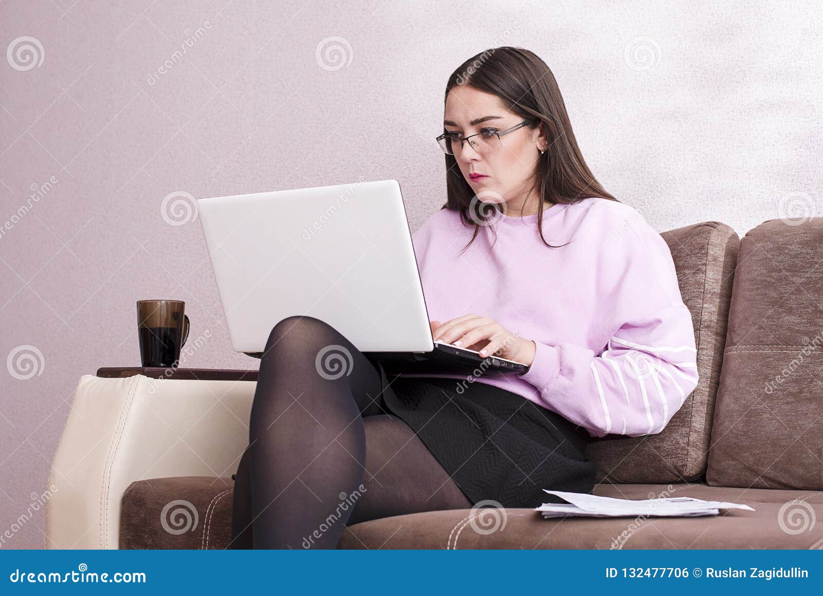 Student Study Sitting on the Couch and Studying the Material on the ...