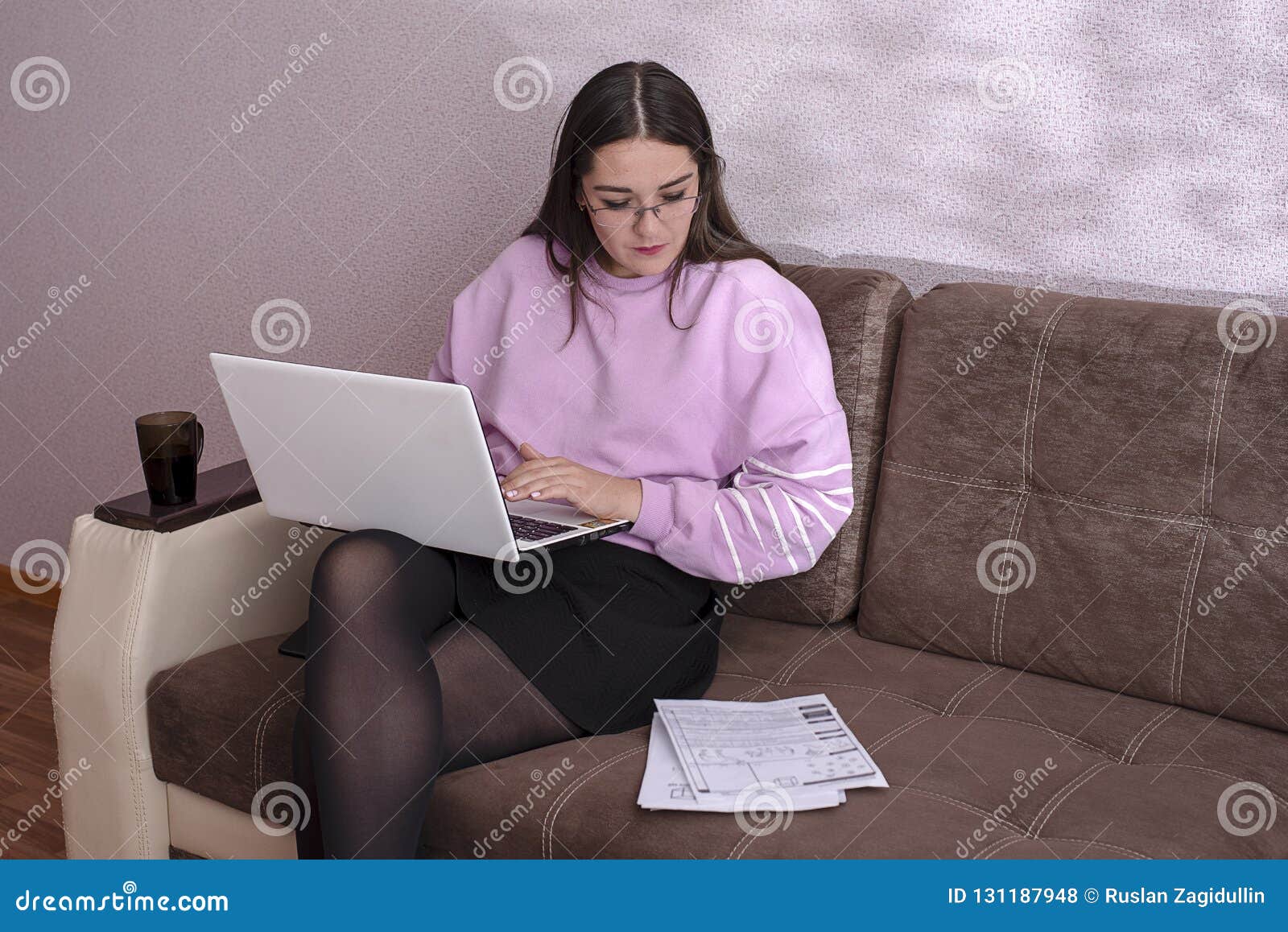 Student Study Sitting on the Couch and Studying the Material on the ...