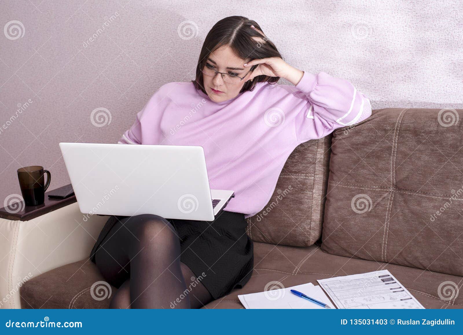 Student Study Sitting on the Couch and Studying the Material on the ...