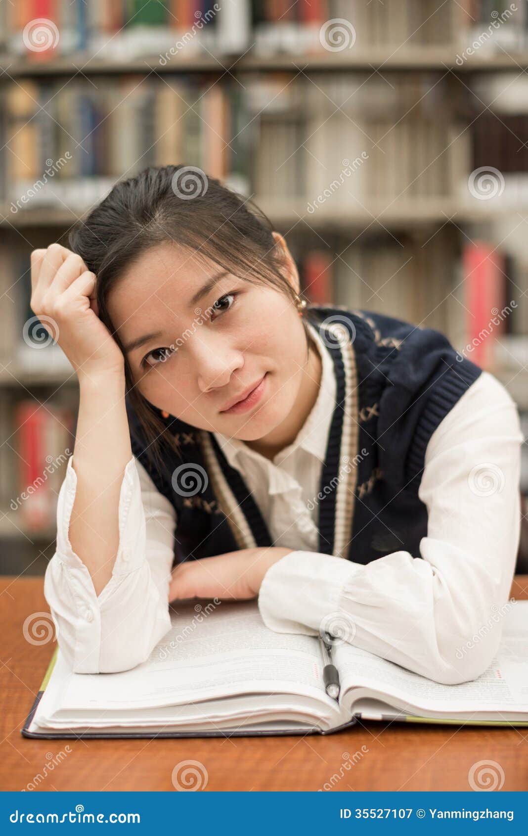 Student Studying at a Desk in Library Stock Image - Image of pages ...