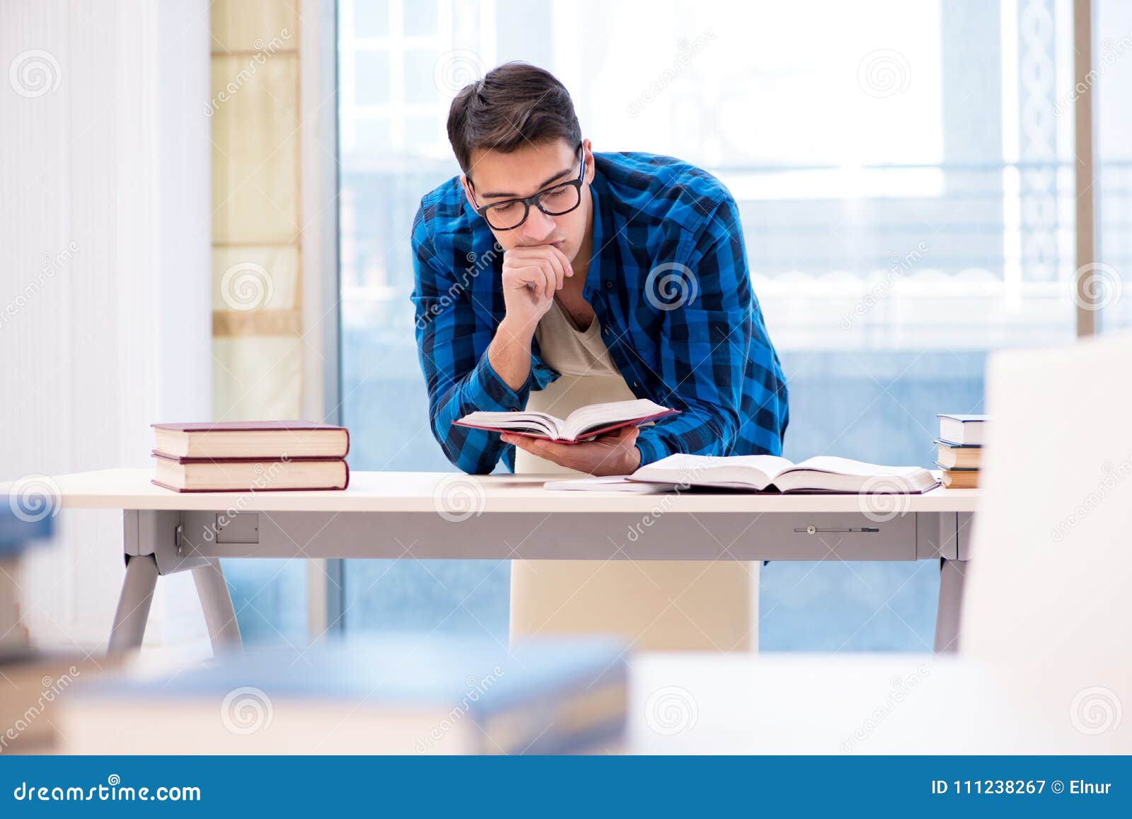 Student Studying in the Empty Library with Book Preparing for Ex Stock ...