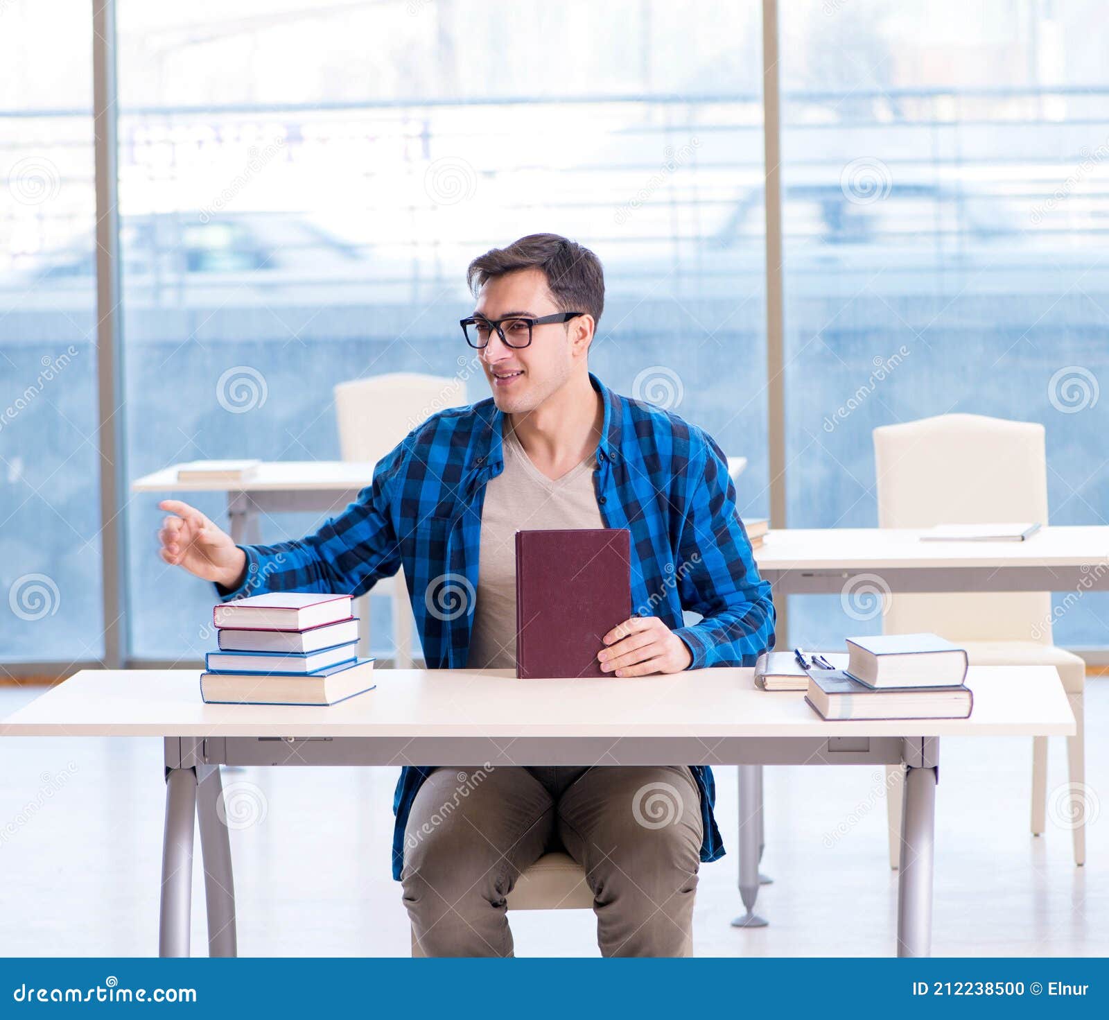 Student Studying in the Empty Library with Book Preparing for Ex Stock ...