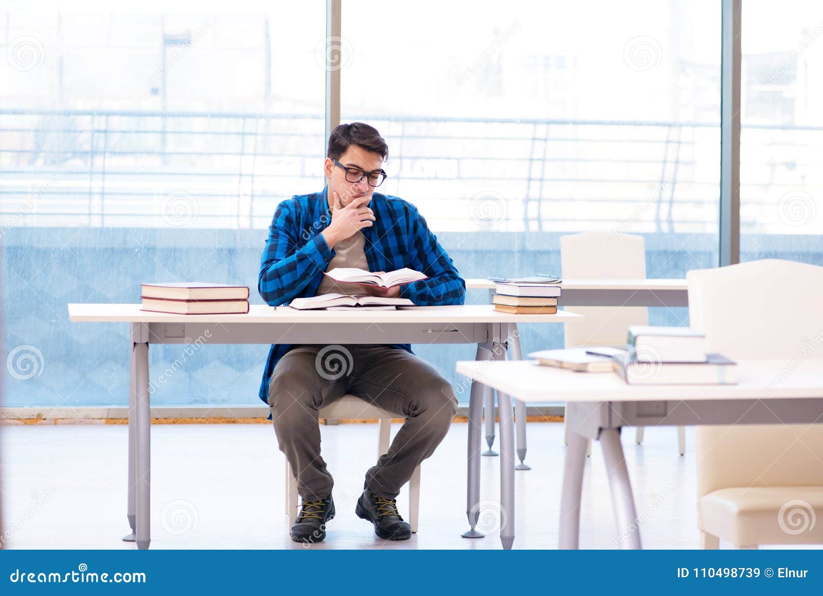 Student Studying in the Empty Library with Book Preparing for Ex Stock ...