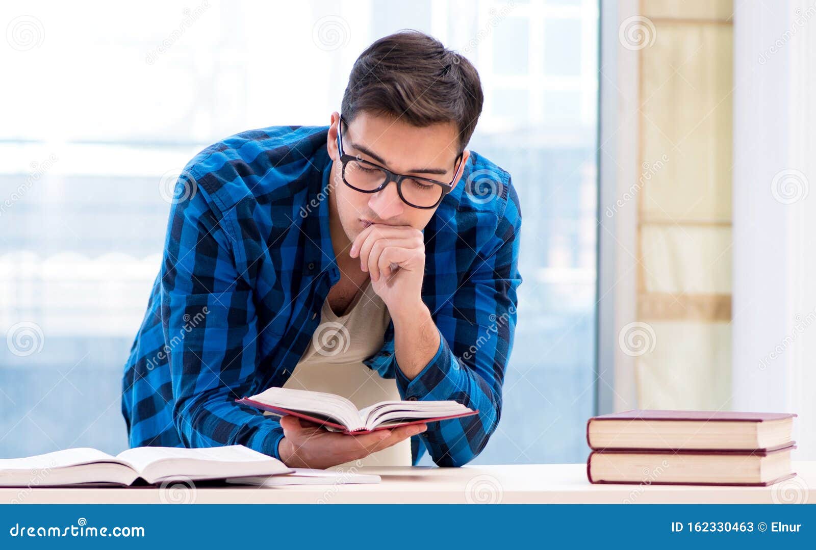 Student Studying in the Empty Library with Book Preparing for Ex Stock ...