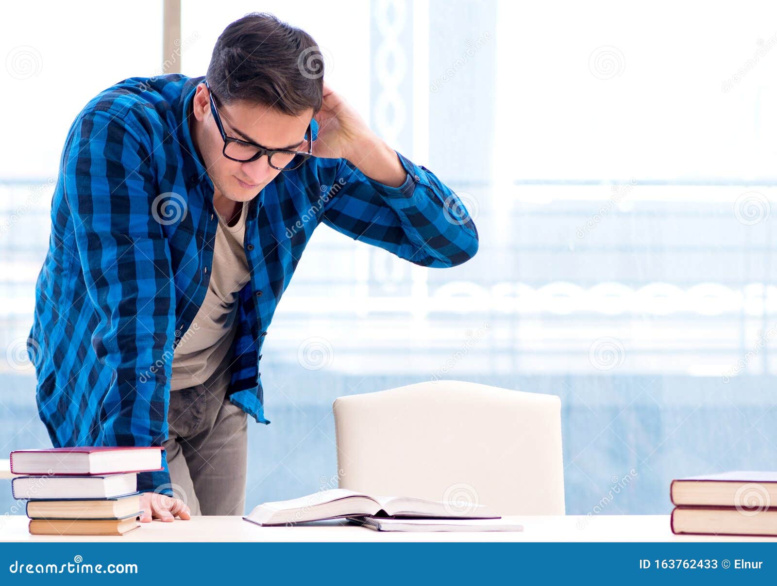Student Studying in the Empty Library with Book Preparing for Ex Stock ...