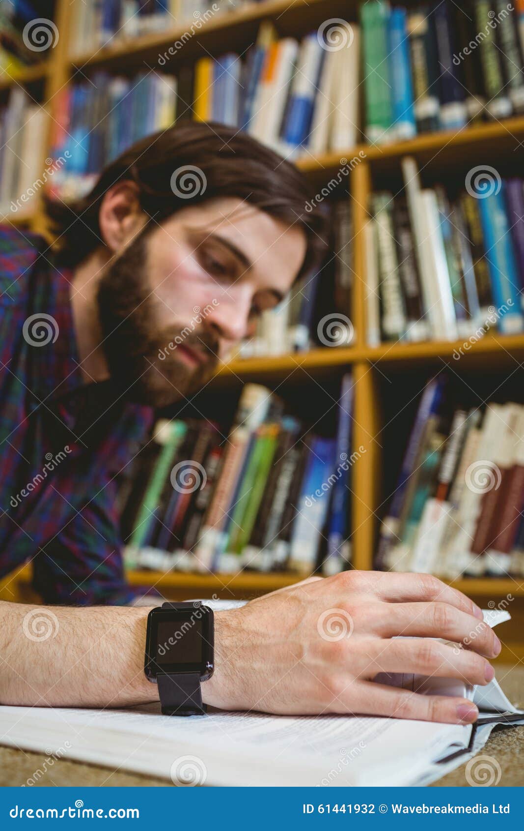 Student Studying on Floor in Library Wearing Smart Watch Stock Photo ...
