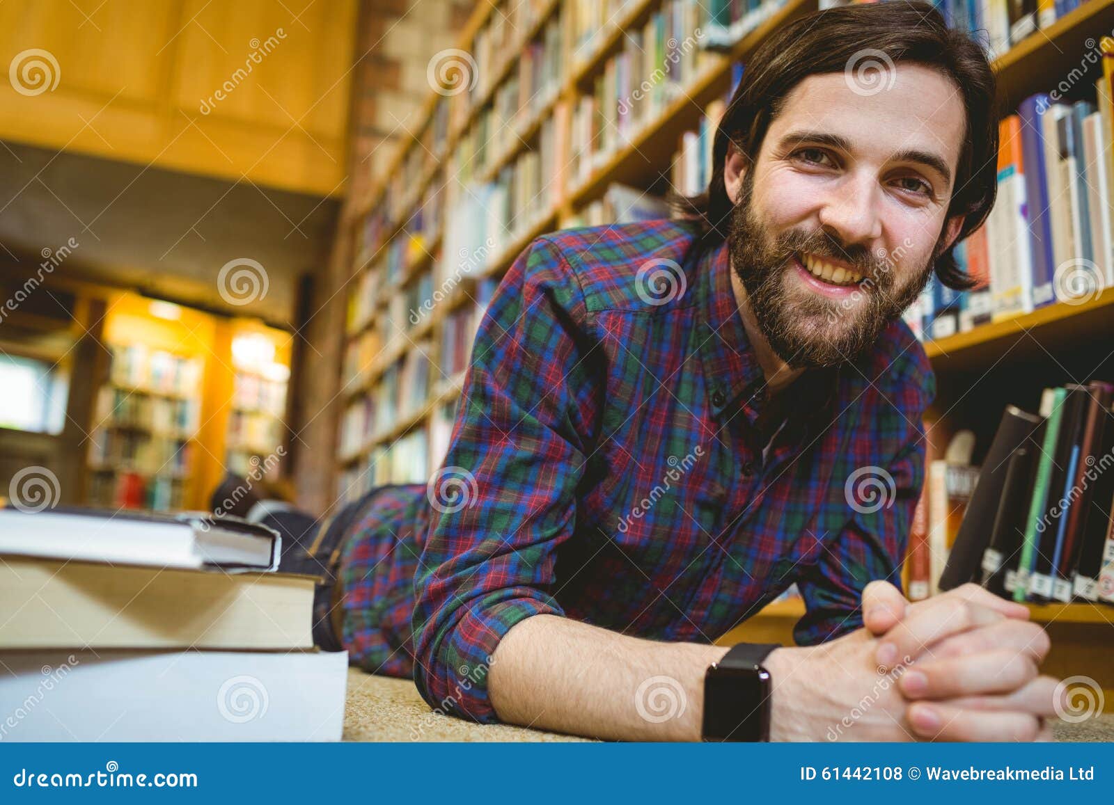 Student Studying on Floor in Library Wearing Smart Watch Stock Photo ...
