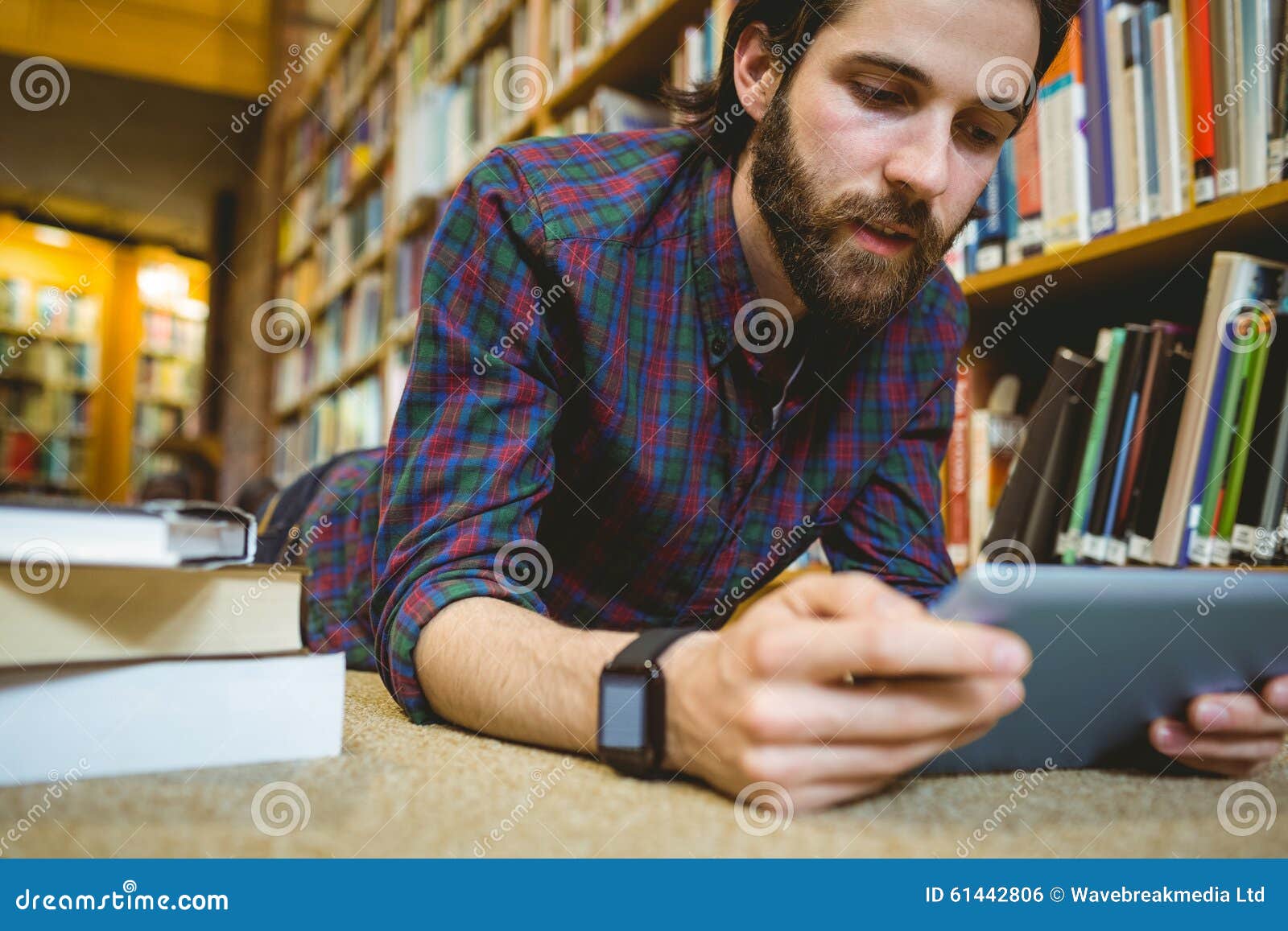 Student Studying on Floor in Library Wearing Smart Watch Stock Photo ...