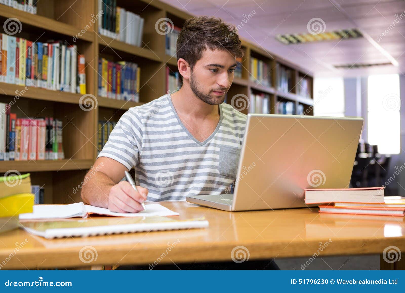 Student Studying in the Library with Laptop Stock Photo - Image of ...