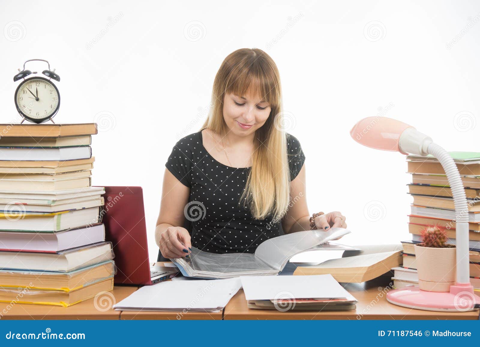 A Student at a Table Littered with Books in Library with a Smile ...