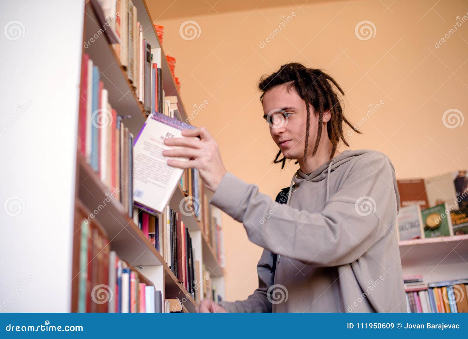 Student Taking a Book from Bookshelf Stock Image - Image of learning ...