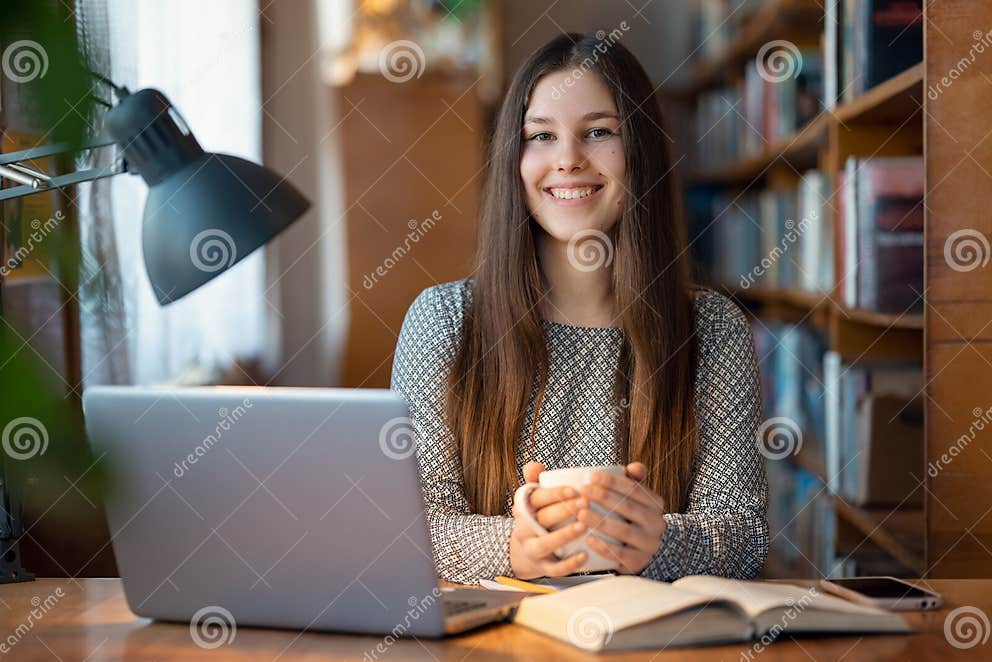 Preparing for Classes at University Library: Young Student Girl Sitting ...