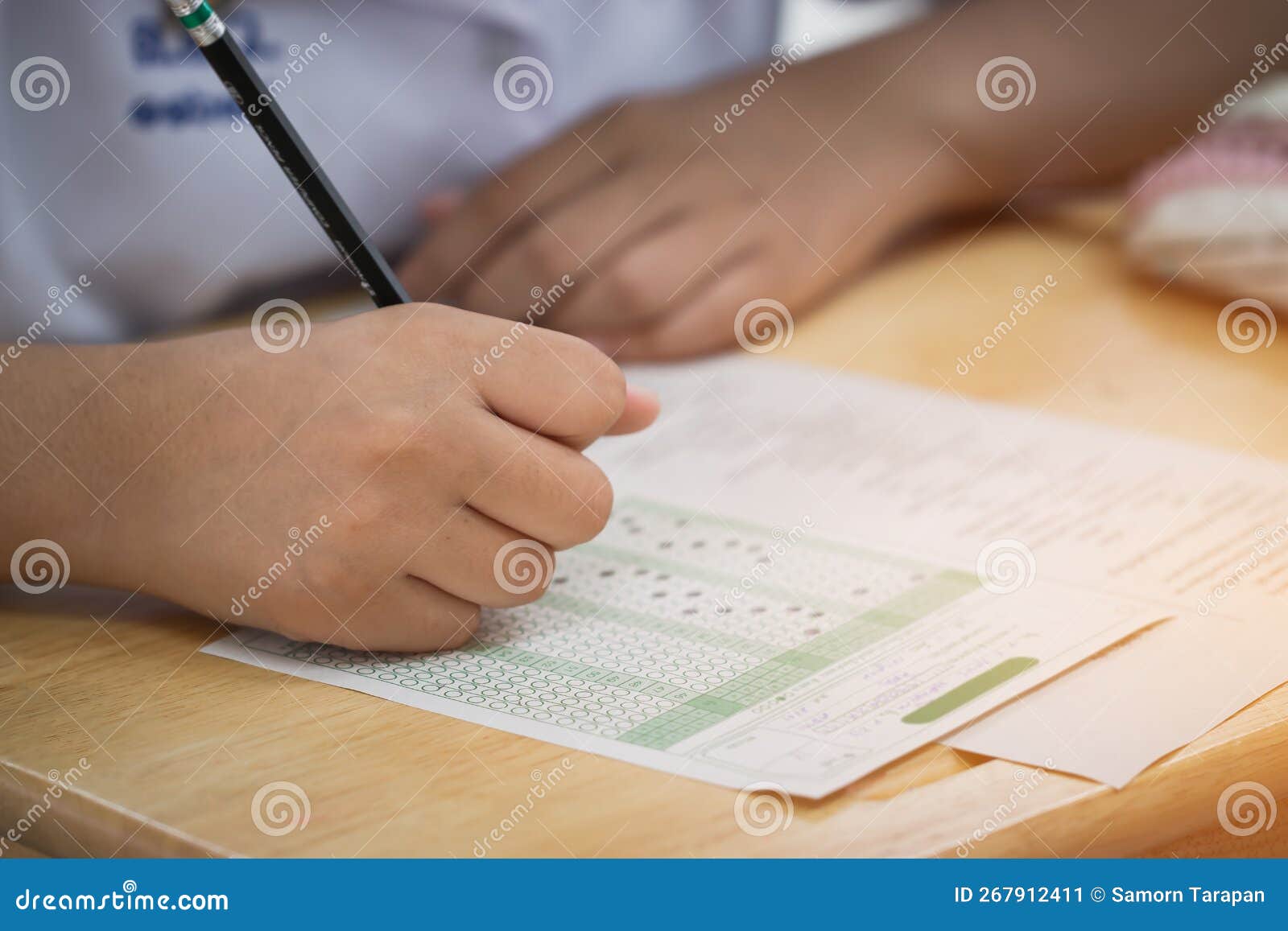 Student Taking Exams, Writing Examination on Paper Answer Sheet Optical ...