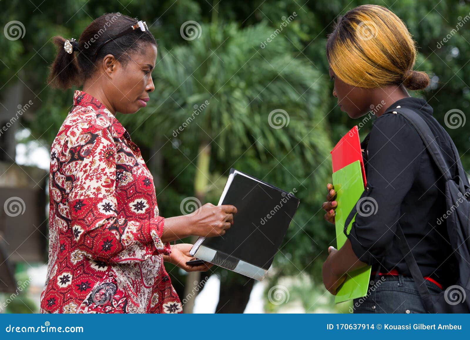 Student Talking with a Teacher Outdoors Stock Photo - Image of coats ...