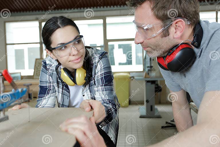 Student and Teacher in Carpentry Class Using Saw Stock Photo - Image of ...