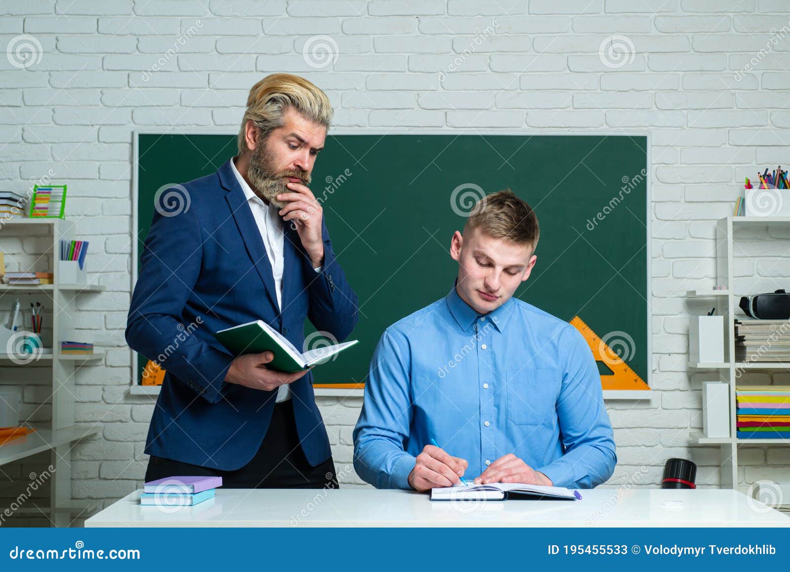 Student and Teacher. Teacher Helping Students with Assignment, Stock ...