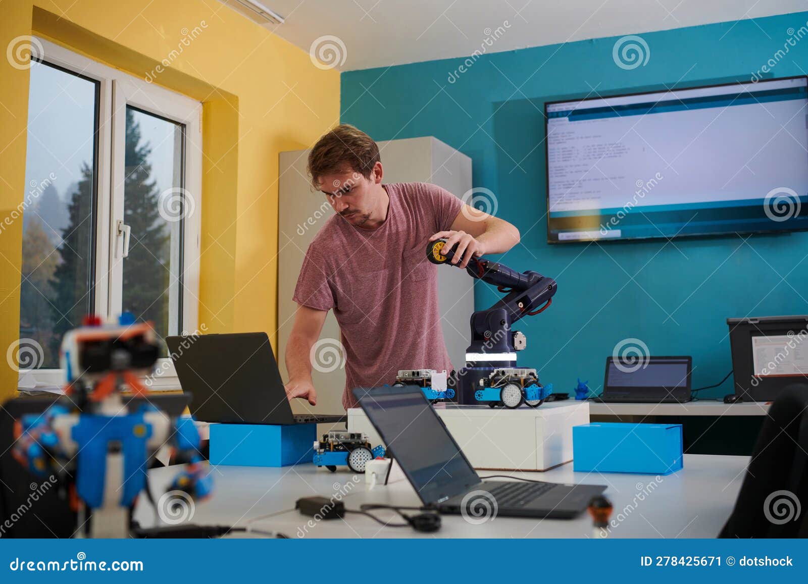 A Student Testing His New Invention of a Robotic Arm in the Laboratory ...