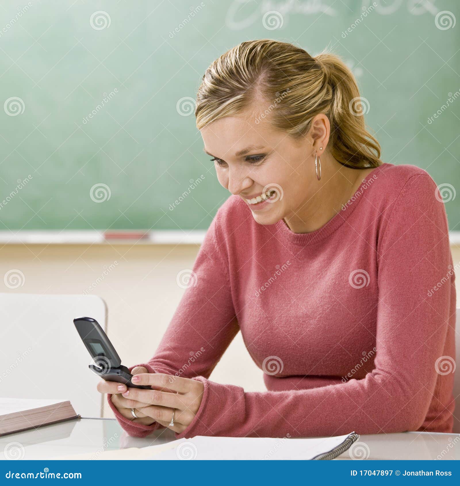 Student Text Messaging on Cell Phone in Classroom Stock Image - Image ...