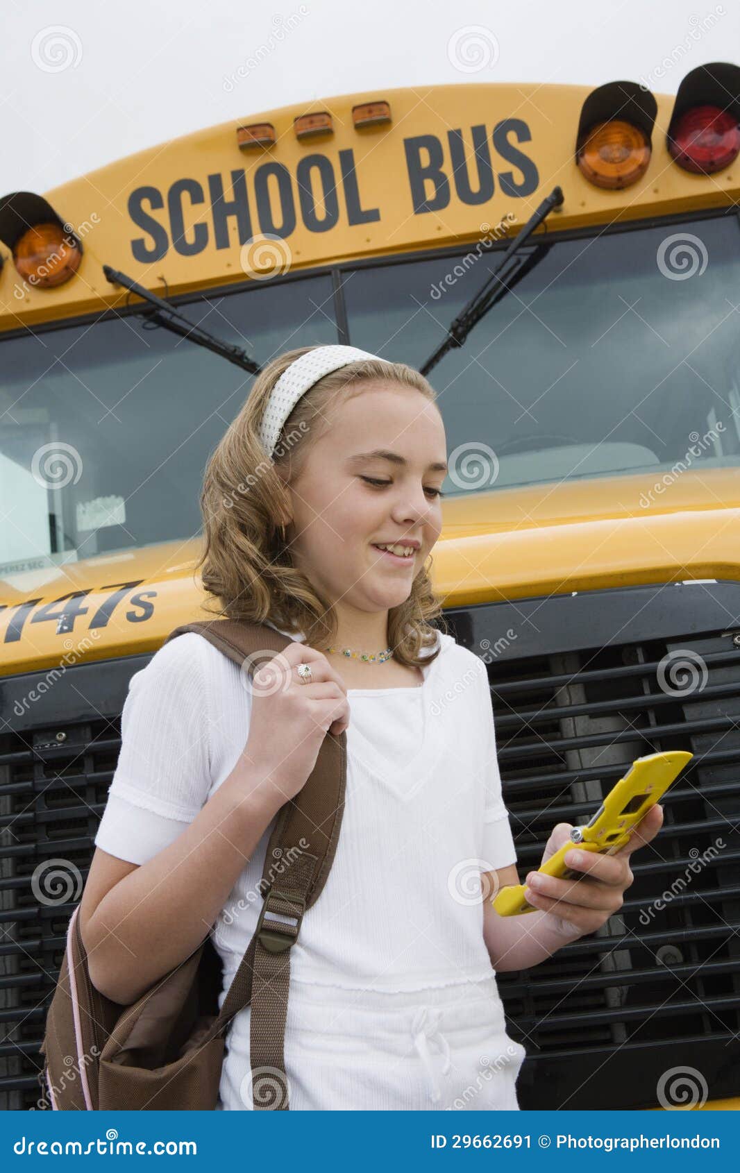 Student Text Messaging by School Bus Stock Image - Image of college ...