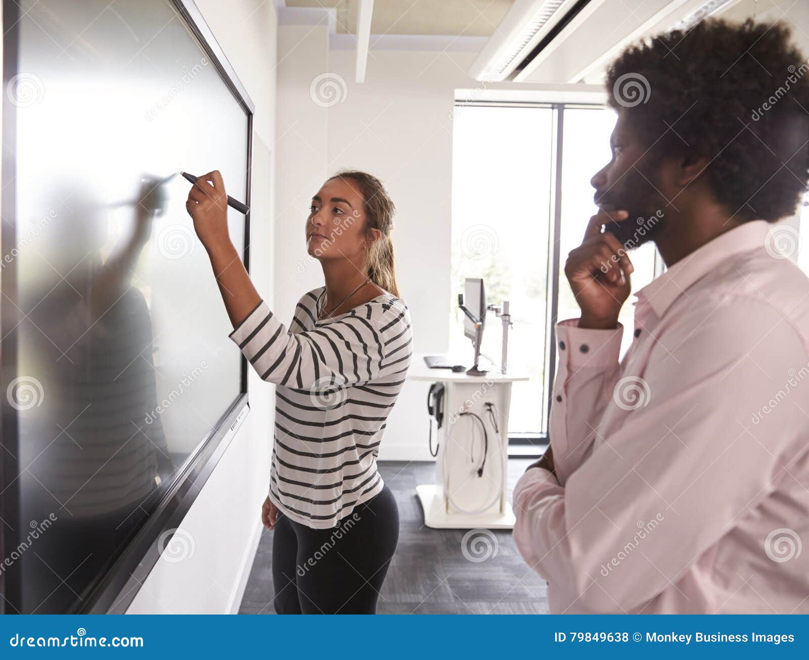 Student and Tutor Discuss Project on Interactive Whiteboard Stock Photo ...