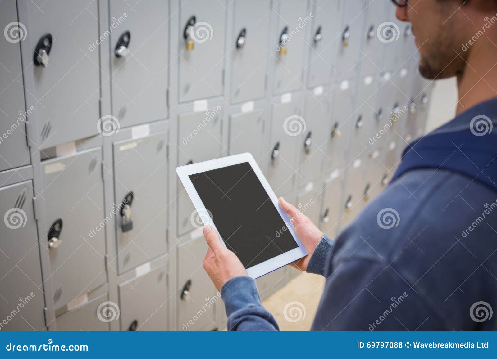 Student Using Digital Tablet in Locker Room Stock Photo - Image of ...