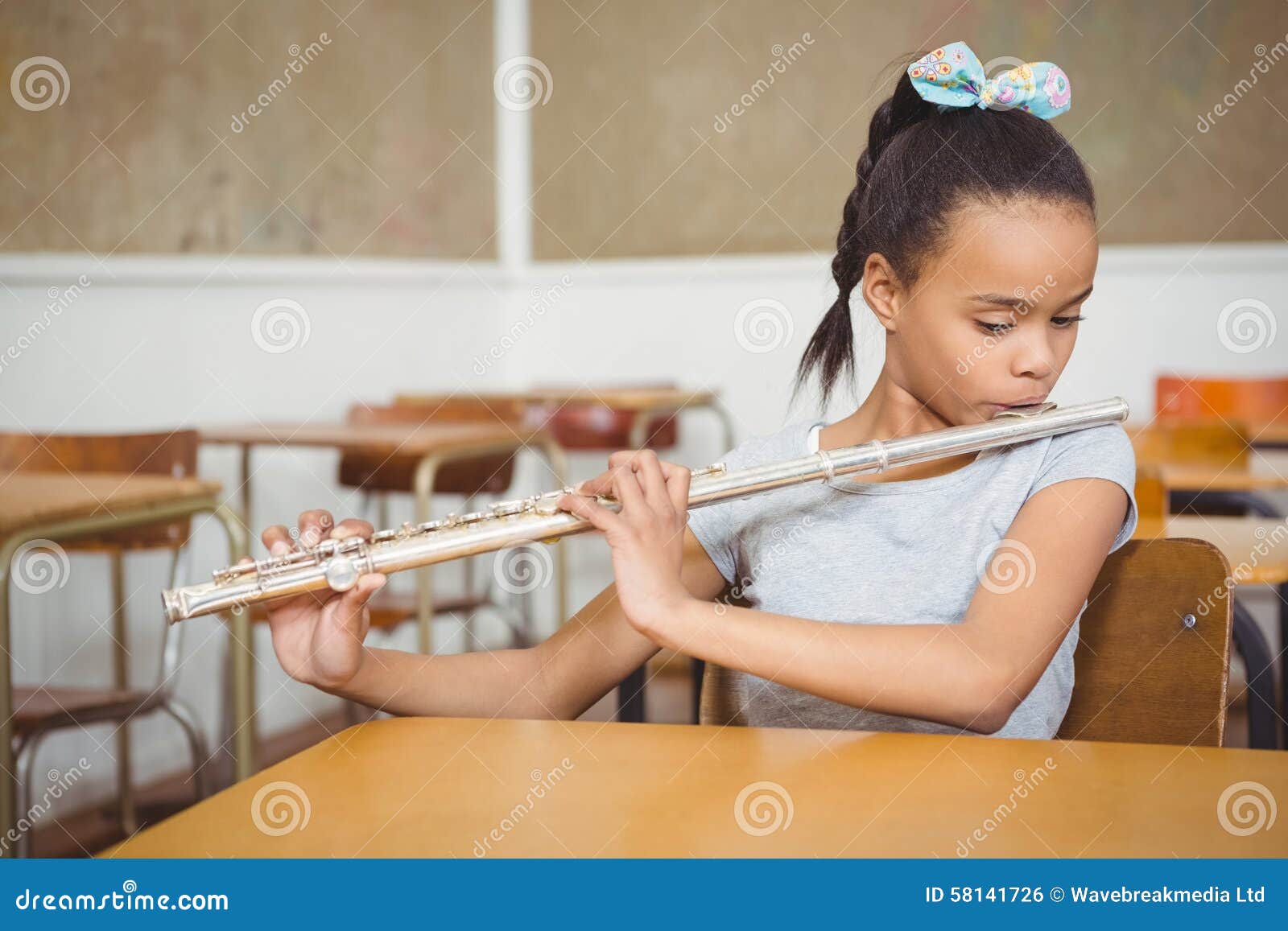 Student Using a Flute in Class Stock Photo - Image of sitting ...