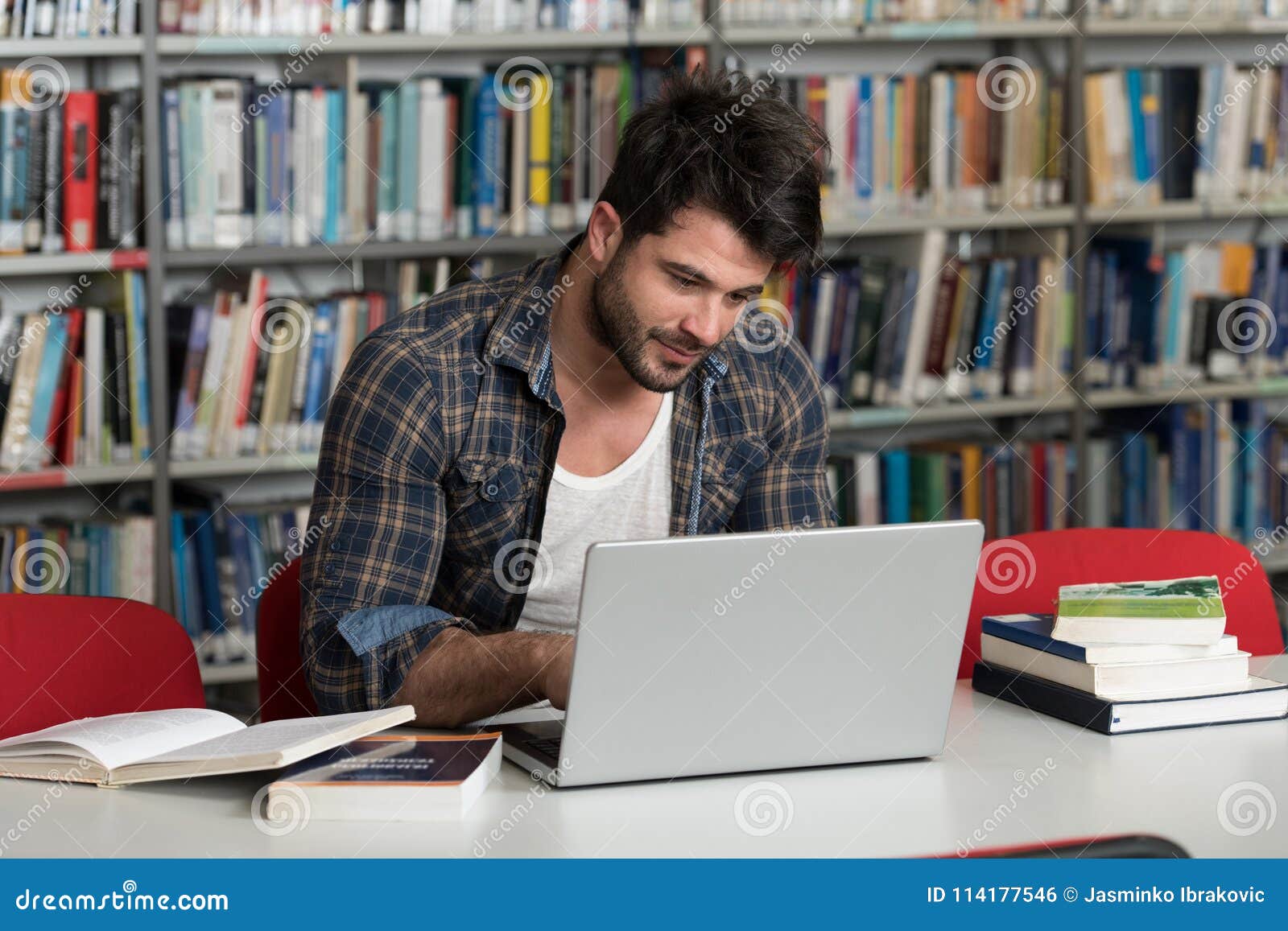 Student Using His Laptop in a Library Stock Photo - Image of closeup ...