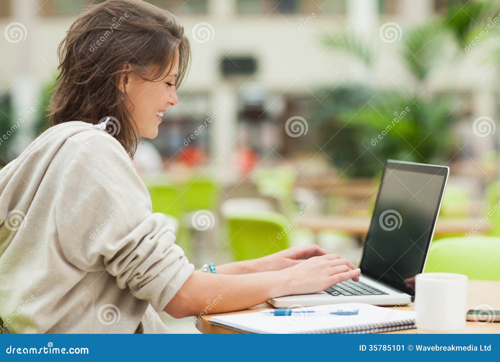 Student Using Laptop at Cafeteria Table Stock Image - Image of computer ...