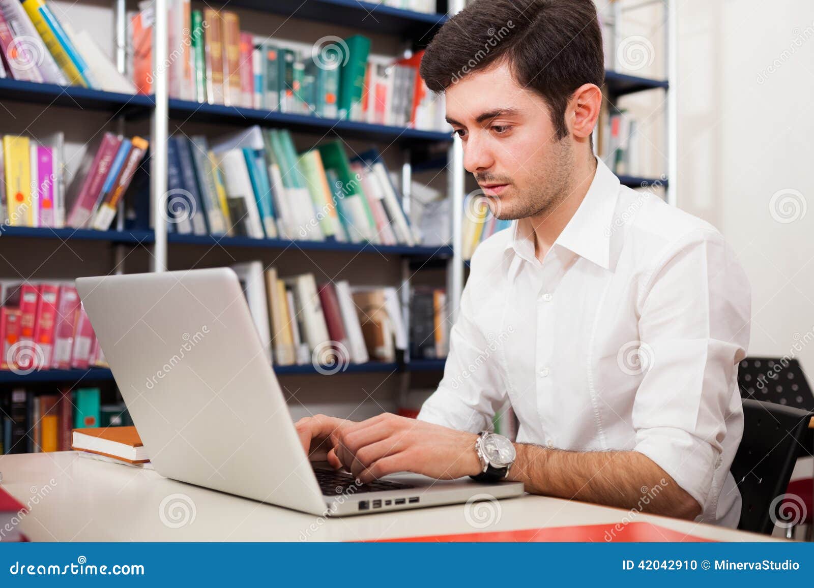 Student Using a Laptop in a Library Stock Photo - Image of contact ...