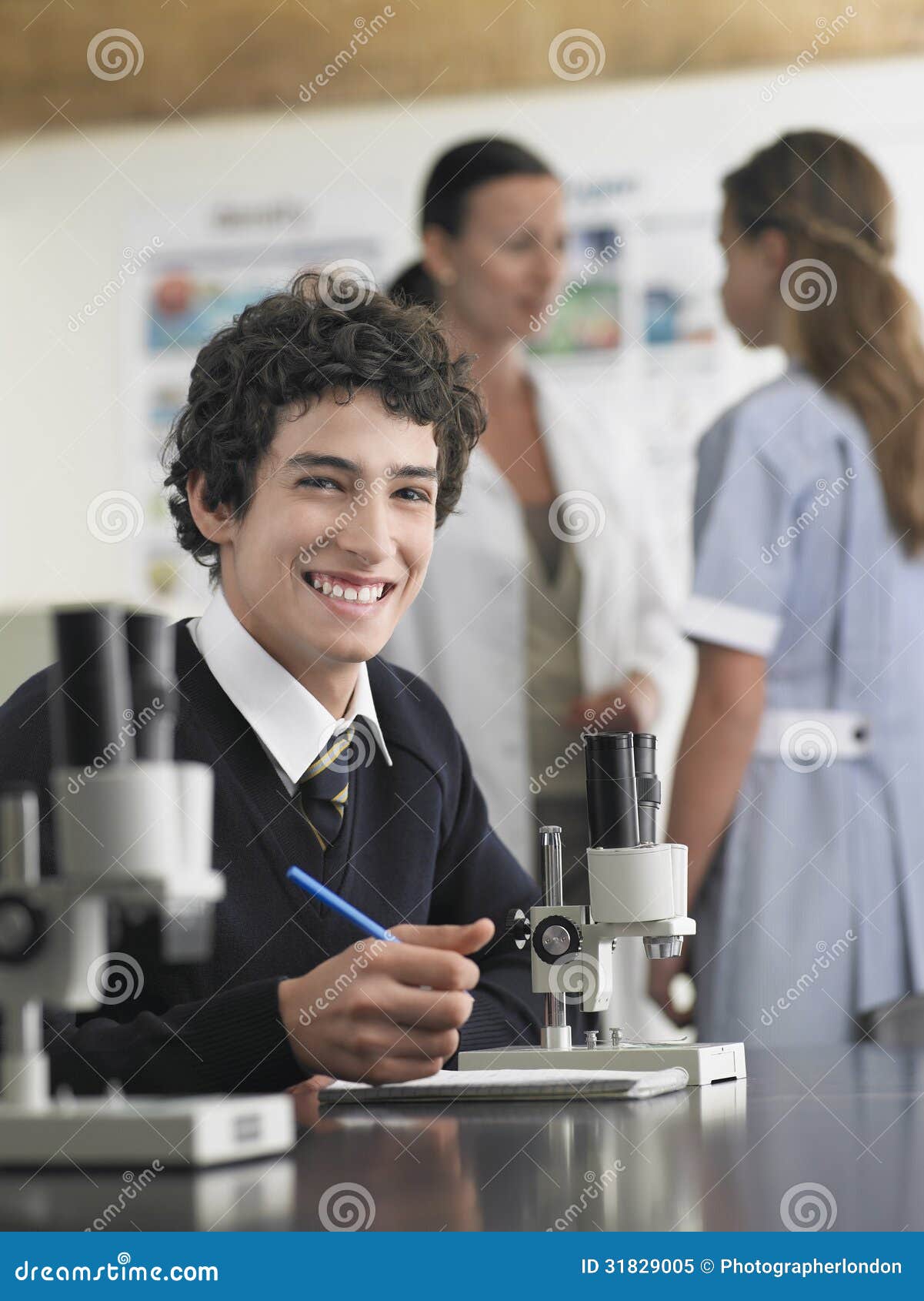 Student Using Microscope and Taking Notes in Laboratory Stock Image ...