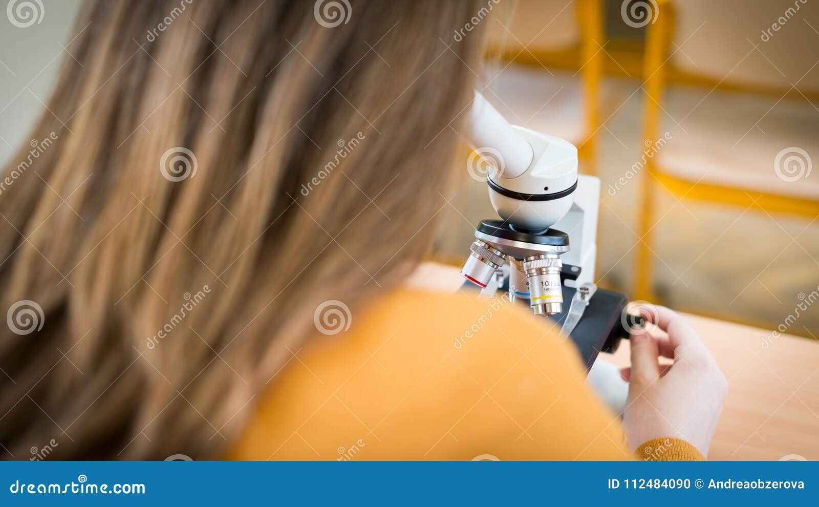 Student Using Microscope To Examine Samples in Biology Class. Stock ...