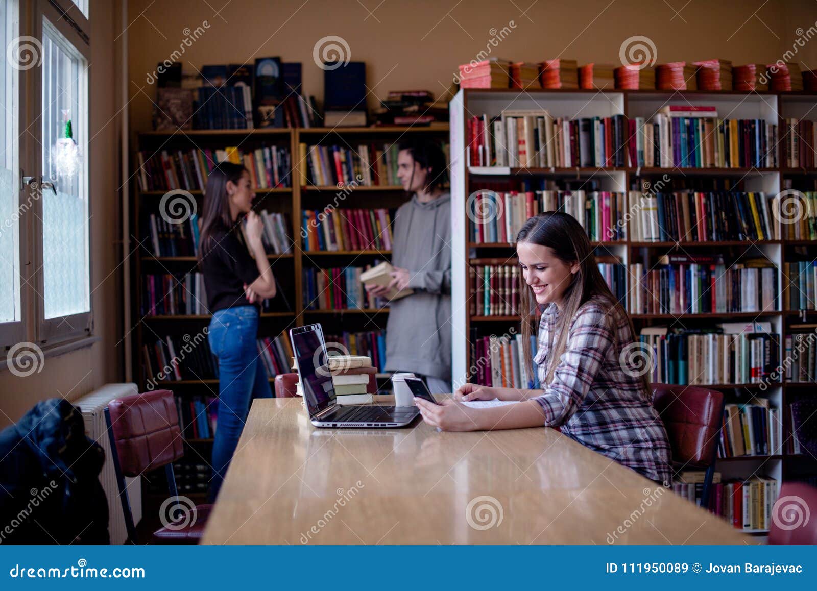 Student Using Mobile Phone in Library Stock Image - Image of adults ...