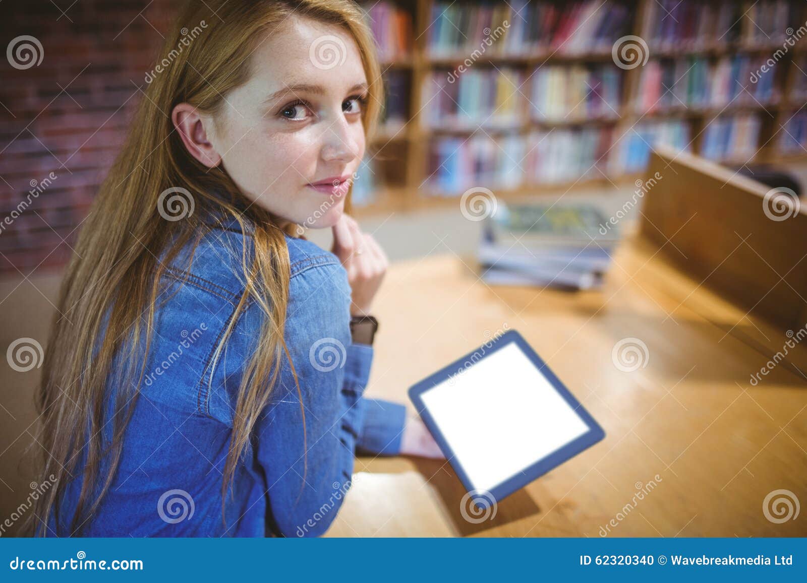 Student Using Tablet in Library Looking Back at the Camera Stock Photo ...