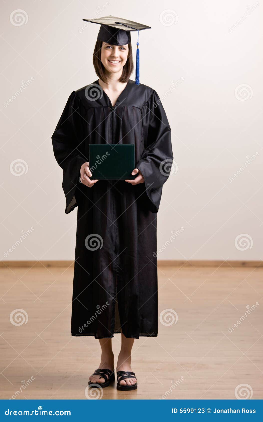 Student Wearing Cap and Gown Holding Diploma Stock Image - Image of ...