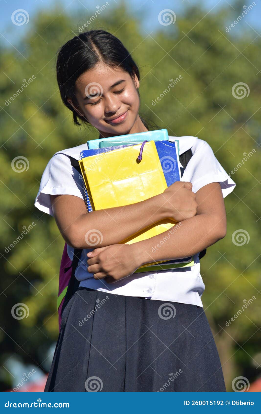 A Student Wearing Uniform Holding Textbooks Stock Photo - Image of ...