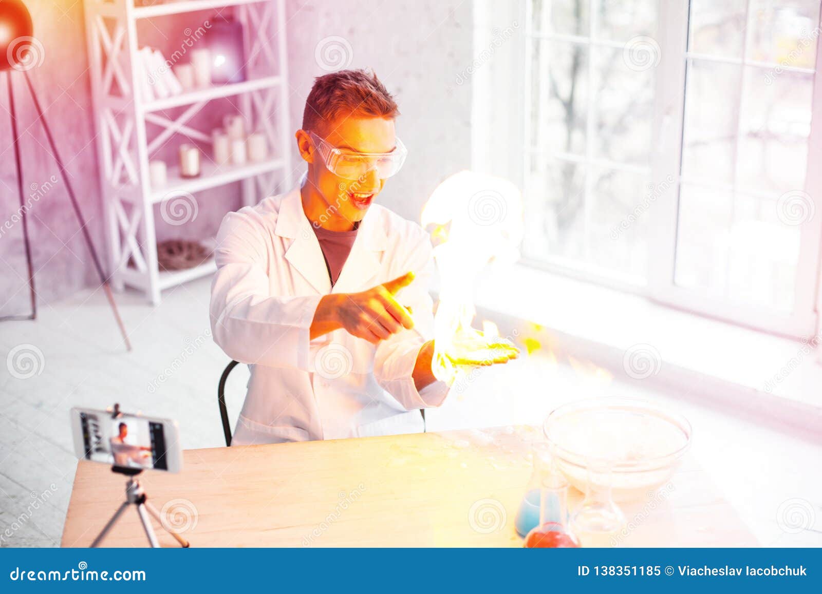 Student Wearing White Lab Coat Making Experiment with Fire in Front of ...