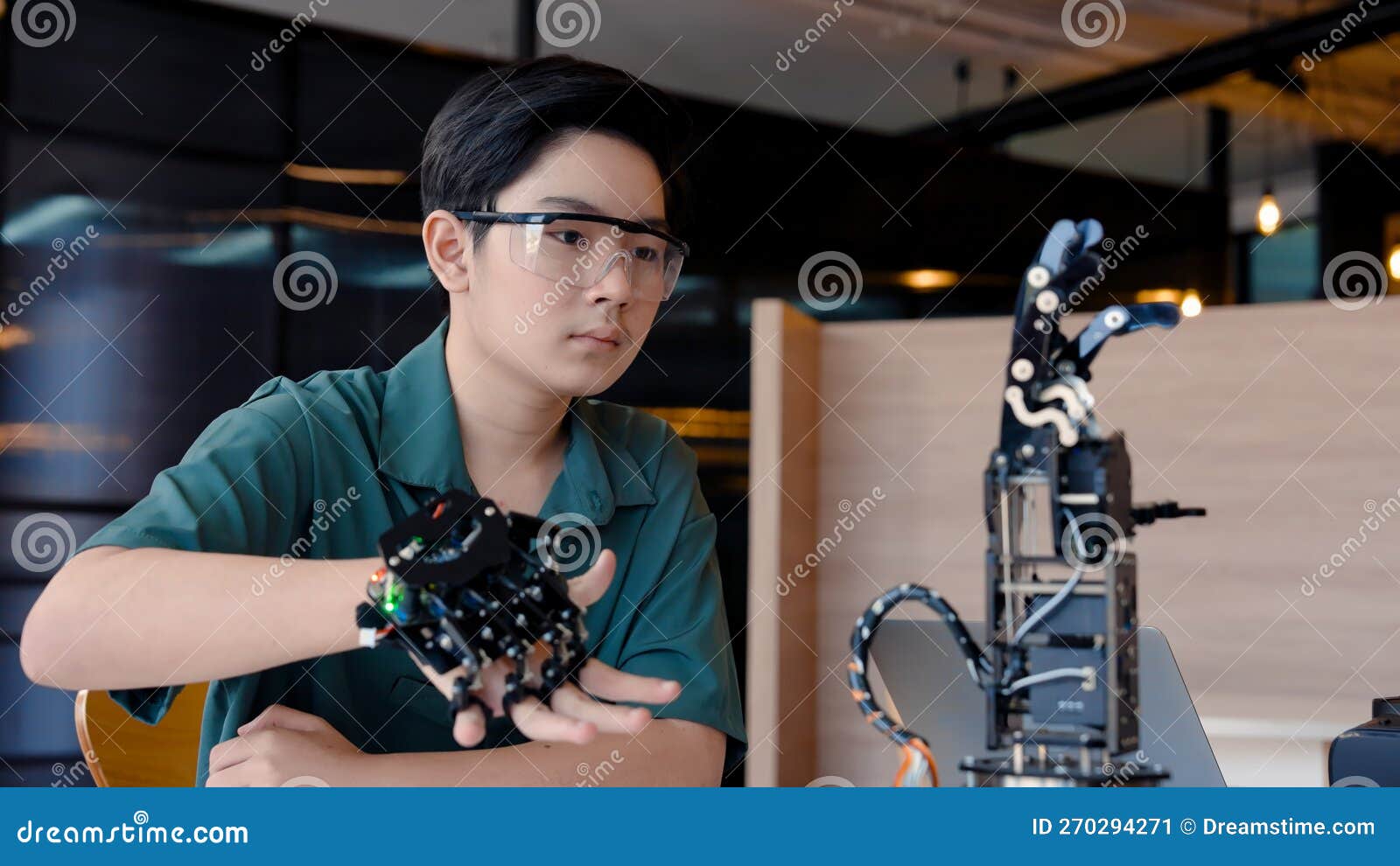Student Wearing Wireless Controller Moves Robotic Hand. Move Hand Back ...