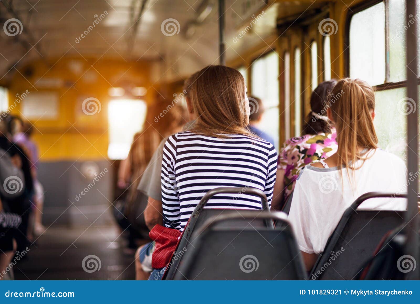 Student Women Taking a Ride in Public Transport from the Work at Sunset ...