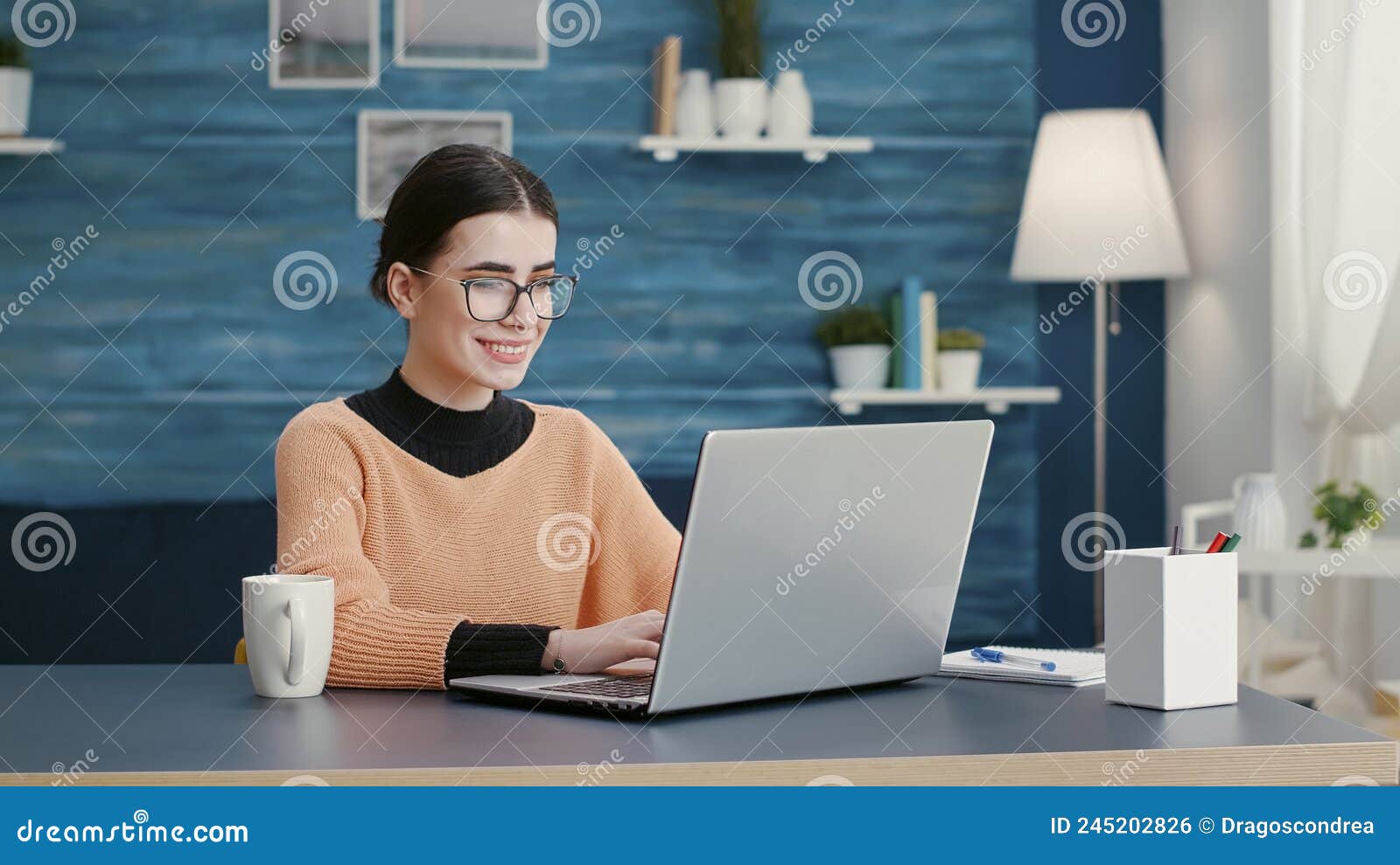 Student Working on Laptop at Desk To Create School Project Stock Photo ...