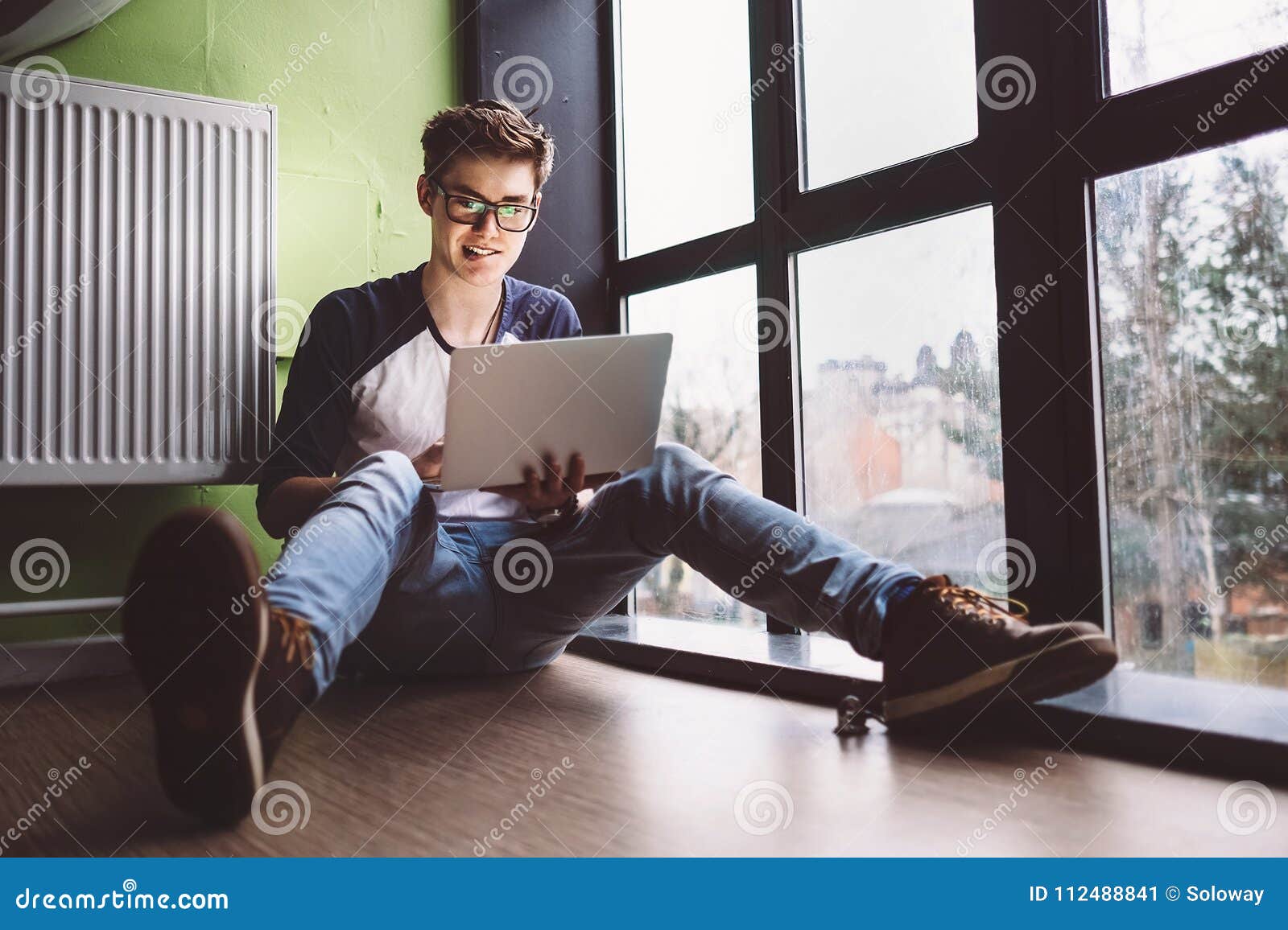A Man With A Laptop Sits In The Server Room Of The Data Center. The ...