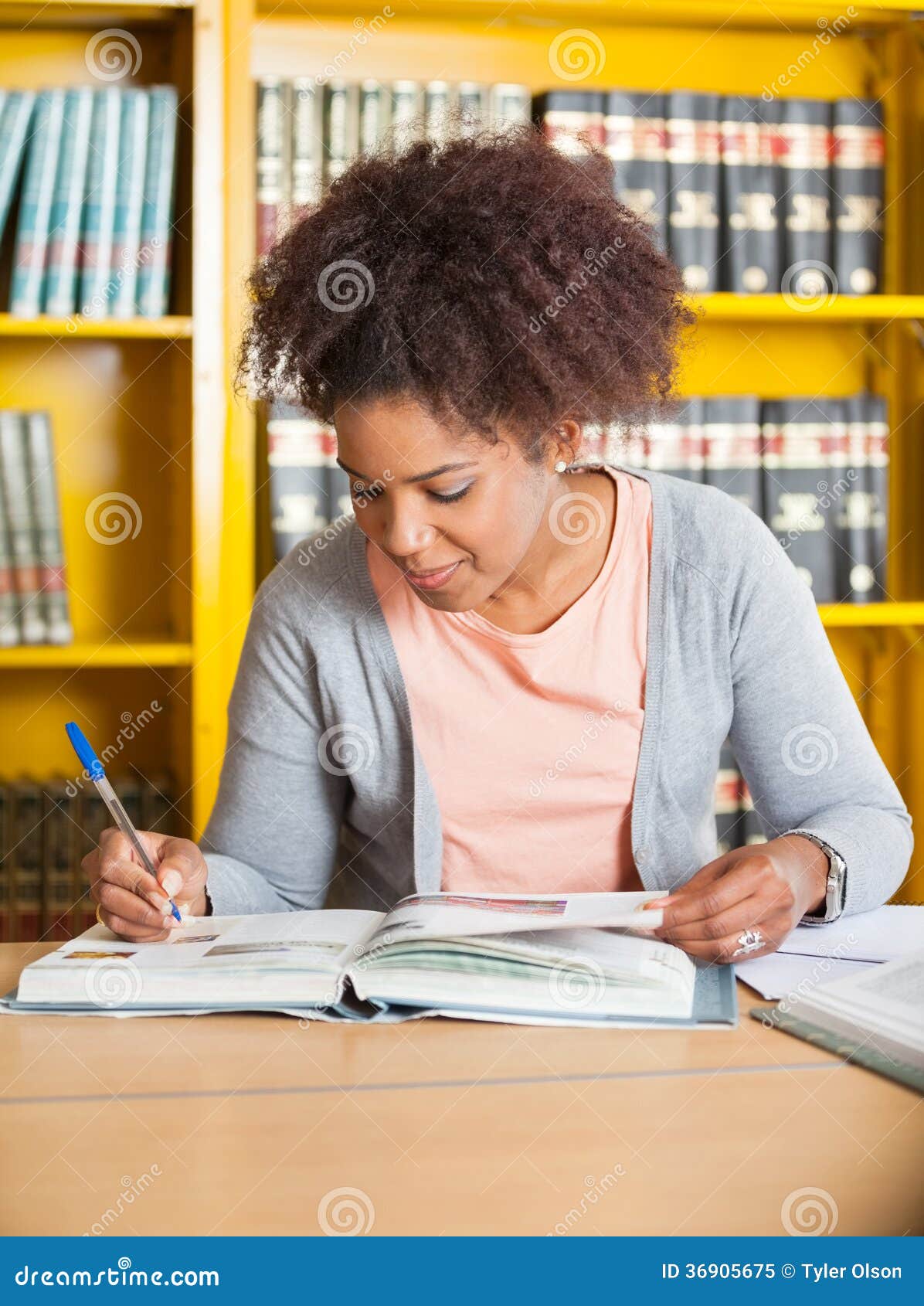 Student Writing in Book at Library Stock Image - Image of library ...